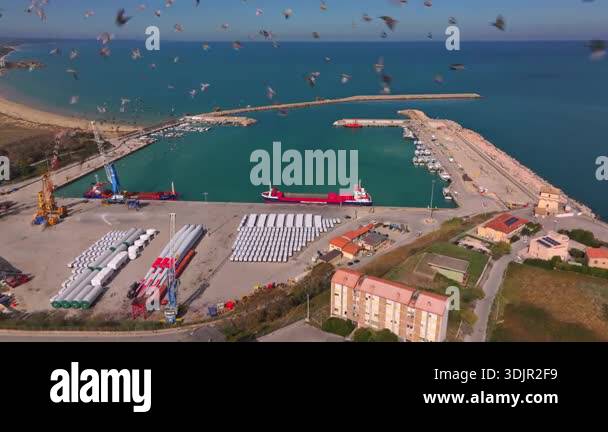 Aerial footage of Vasto port showing harbor infrastructure, cargo ships ...