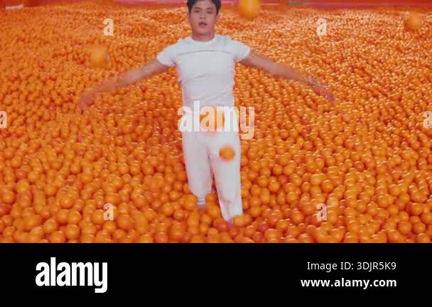 An action shot of a fit man jumping up from a crouching position in a ...