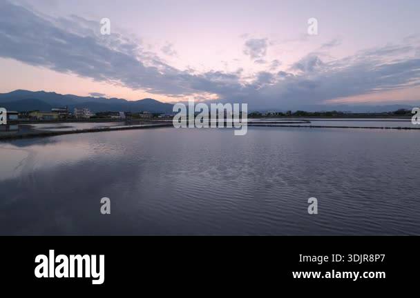 A serene twilight scene over flooded rice paddies in Yilan County ...