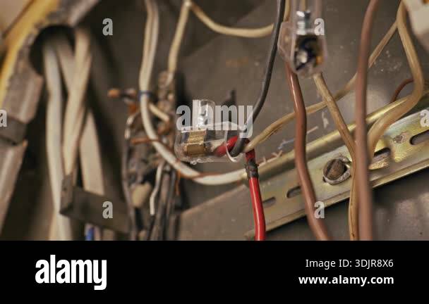 Messy electrical wiring connects to clear plastic terminals and circuit ...