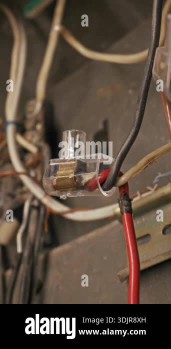 Complex electrical wiring connects through transparent splice terminals ...