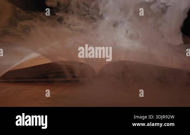 An open book lies on a wooden surface as thick white smoke swirls ...
