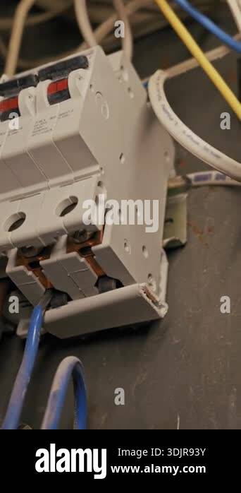 White circuit breakers connected to brown and blue wires inside a fuse ...