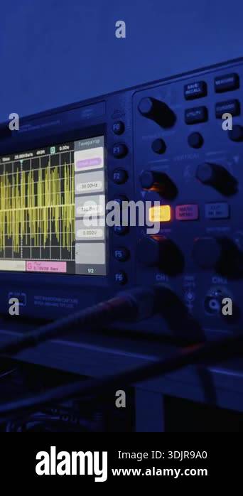 A digital oscilloscope screen displays a complex yellow signal waveform ...