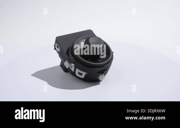 Mirror adjustment switch rotates on a minimal white background. Clean ...