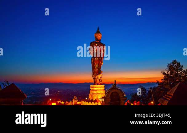 Time lapse A majestic golden Buddha statue stands peacefully on a ...