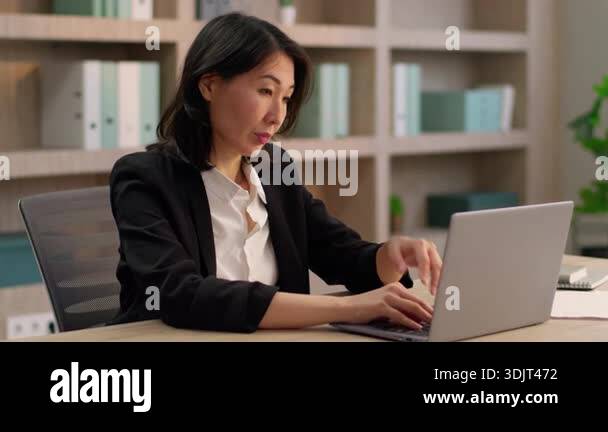 Tired Asian businesswoman typing laptop feeling eyes discomfort Chinese ...