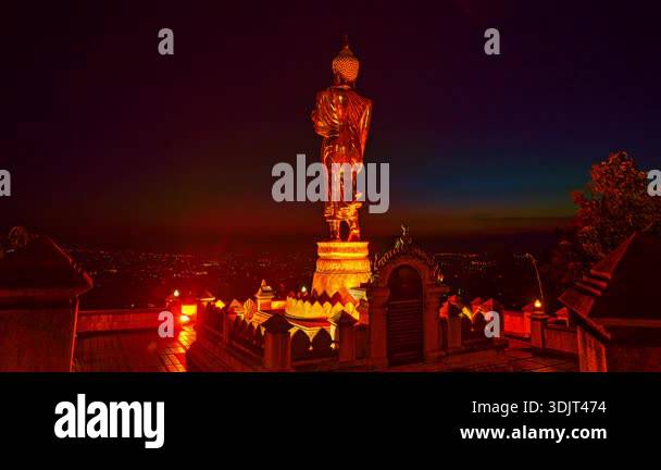 Time lapse A majestic golden Buddha statue stands peacefully on a ...