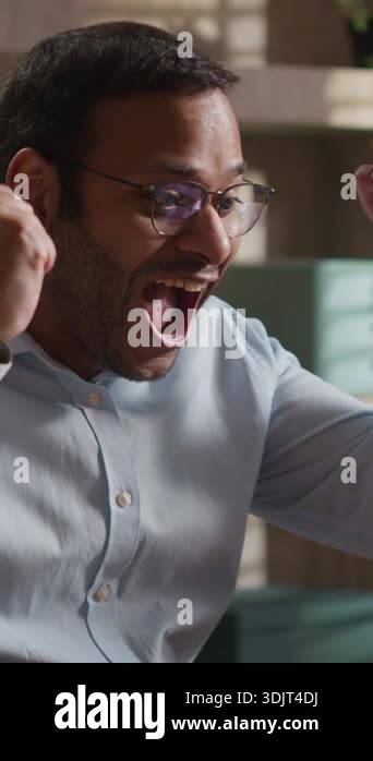 Screaming happy Indian business man shouting with joy at office laptop ...