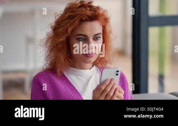 Shocked amazed Caucasian woman looking at smartphone shock at home ...