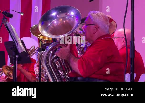 Orlando, Florida, USA - 07.04.2024: A tuba player in a red shirt ...