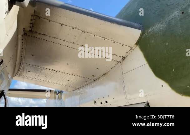 Close view of a vintage military aircraft shows the tail and wing ...