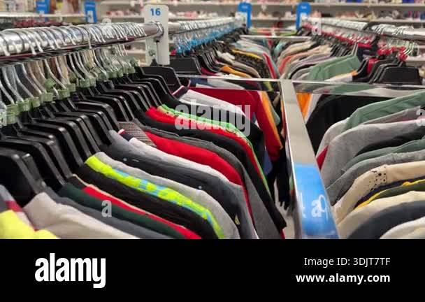 A rack of kids and teen boys T-shirts in bright colors and prints is ...