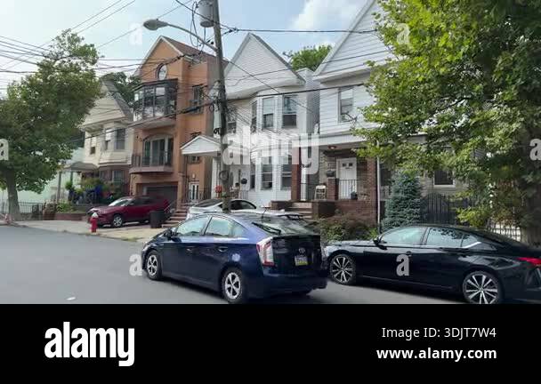 Jersey City, New Jersey State, USA - 07.28.2024: Row houses and parked ...