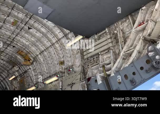 Interior view shows the curved cargo bay ceiling of a large aircraft ...