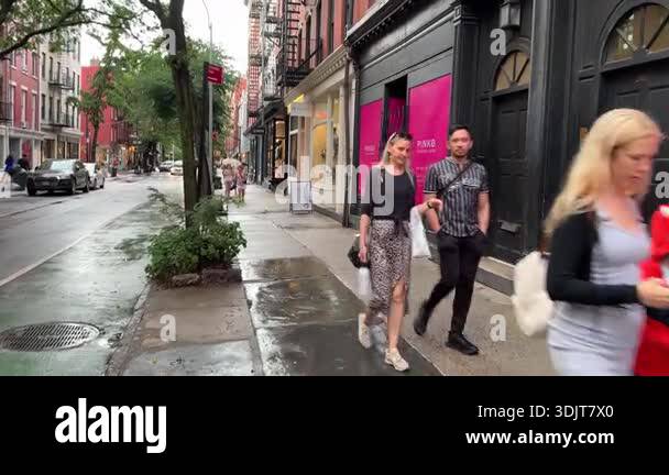 New York, New York State, USA - 08.04.2024: Pedestrians walk along a ...