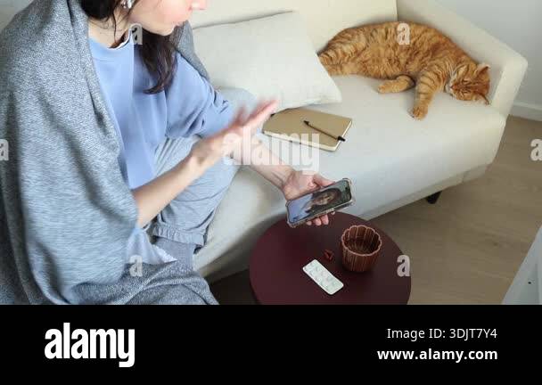 Young sick woman on having home treatment with online help of a doctor ...