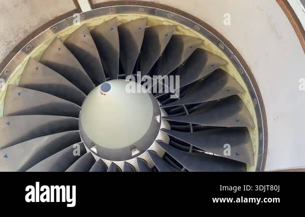 Close-up view shows the circular fan blades of a large jet engine ...