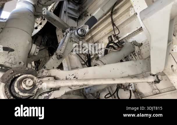 Close-up view shows the complex hydraulic landing gear mechanism of a ...
