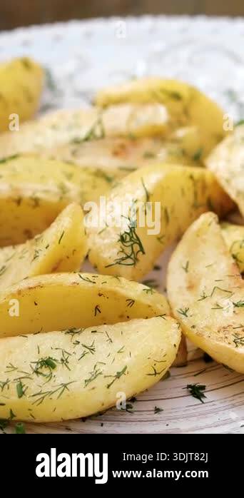 Top view of delicious, seasoned potato wedges with a side of ketchup on ...