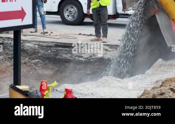 Atlanta, GA / USA - February 27, 2024: Closeup shows dump truck pouring ...