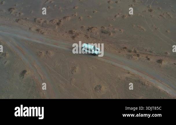 Off-road 4x4 car traveling through arid terrain near coastal beaches of ...