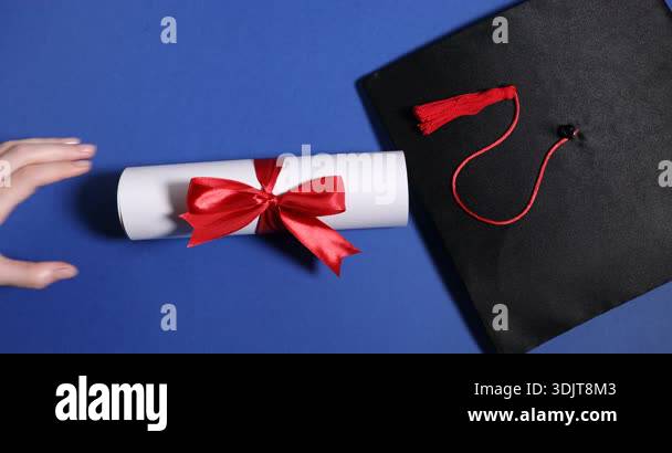 Woman taking diploma and graduation hat on blue background, top view ...