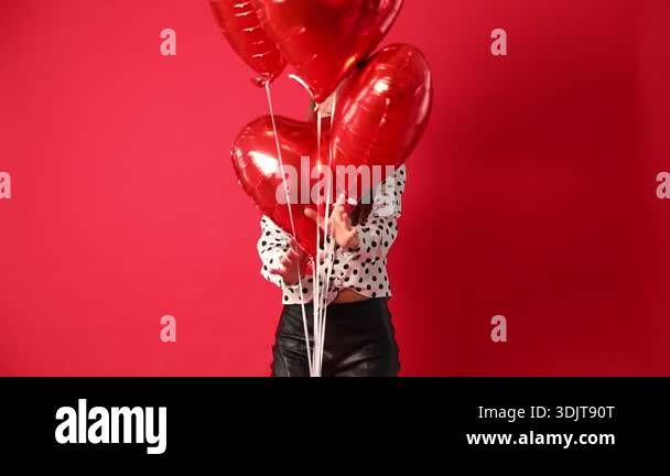 Beautiful woman with heart shaped balloons on red background. Romantic ...