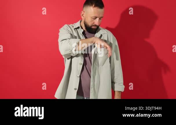Man with hidden spy camera in his pocket on red background. Camera ...