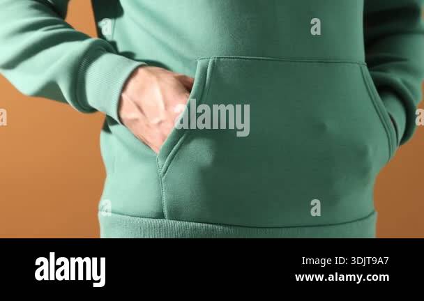 Man with hidden spy camera in his pocket on brown background, closeup ...