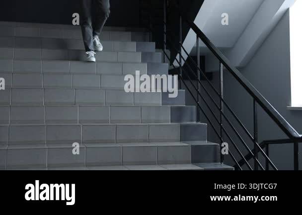 Depressed teenage boy walking down stairs indoors Stock Video Footage ...