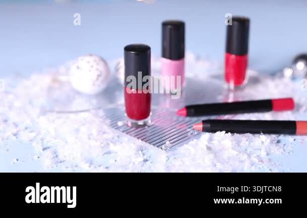 Makeup products and Christmas decor on light blue background with ...