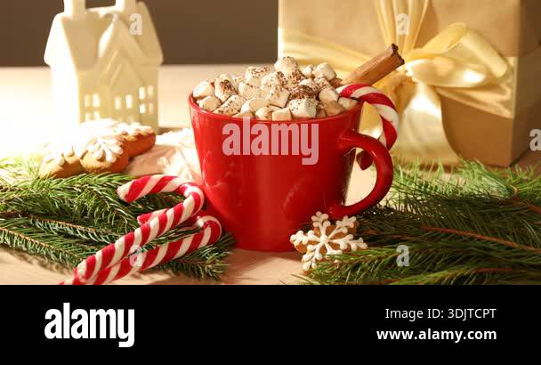 Sprinkling chocolate powder onto tasty cocoa with marshmallows, candy ...