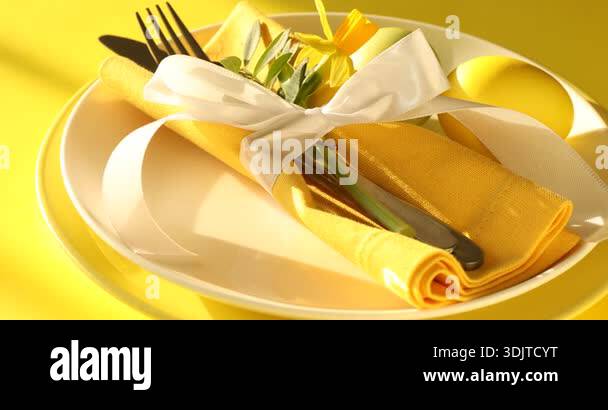 Easter celebration. Festive table setting with daffodil flower and ...