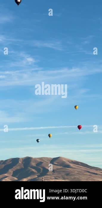 A hot air balloon flies over the city Yerevan, background of the blue ...