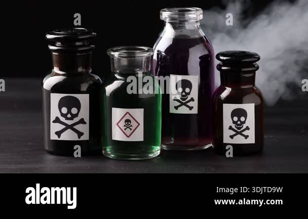 Bottles of poison with warning signs and smoke on dark table against ...