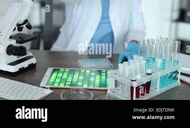 Research in genetics. Scientist taking sample with micropipette at ...