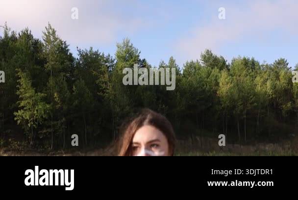 Beautiful shaman woman with face painting and skull walking outdoors ...