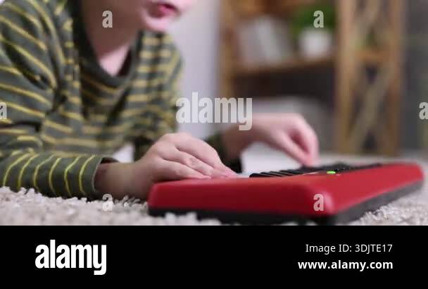 Cute little boy playing toy piano at home, closeup Stock Video Footage ...