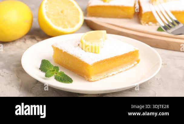 Woman eating tasty lemon bar at grey marble table, closeup Stock Video ...
