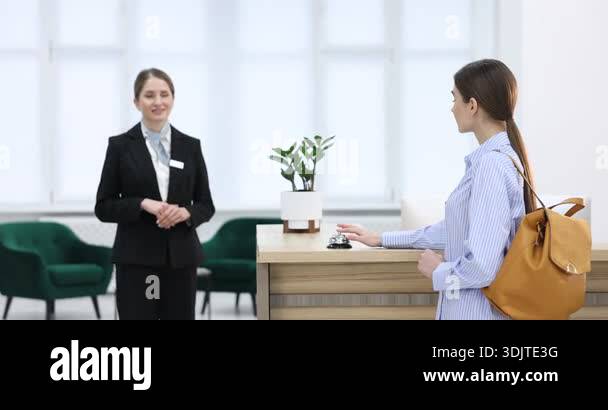 Receptionist working with guest at reception indoors Stock Video ...