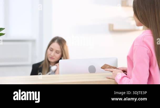 Guest giving passport to receptionist in hotel Stock Video Footage - Alamy