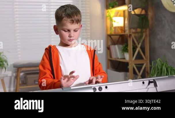 Cute little boy playing piano at home Stock Video Footage - Alamy