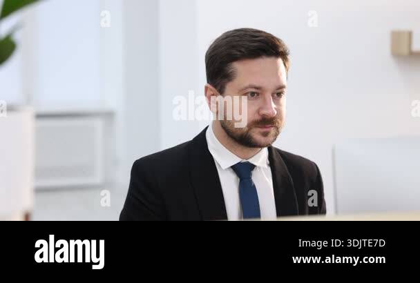 Receptionist talking on telephone at reception desk indoors Stock Video ...