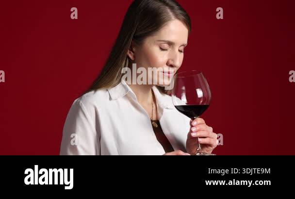 Professional sommelier tasting wine on red background Stock Video ...