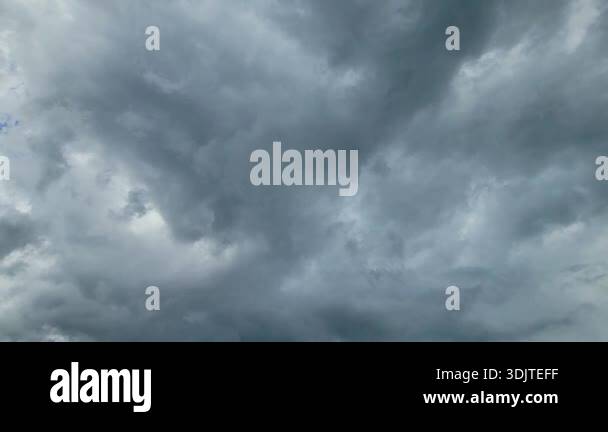 Video footage captures an overcast sky filled with dark, heavy storm ...