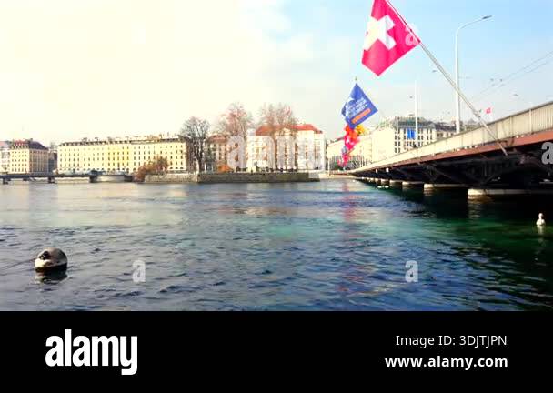 Colorful flags including the Swiss cross above Mont Blanc Bridge in ...