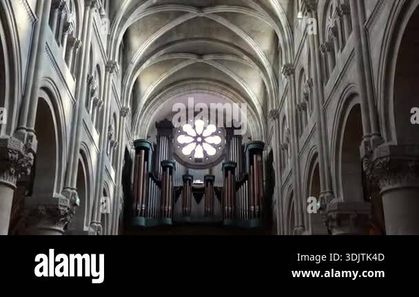 Vaulted stone church with arches organ pipes and stained glass Stock ...