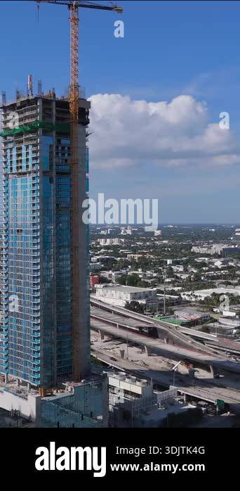 Miami downtown skyscraper construction with crane and unfinished tower ...