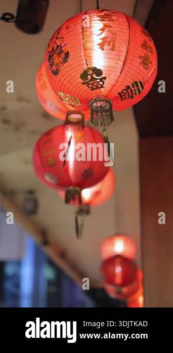 Red Chinese lanterns hang indoors, creating a festive atmosphere with ...